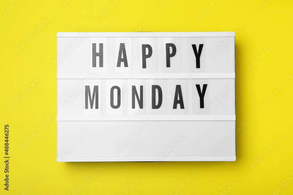 Light box with message Happy Monday on yellow background, top view ...