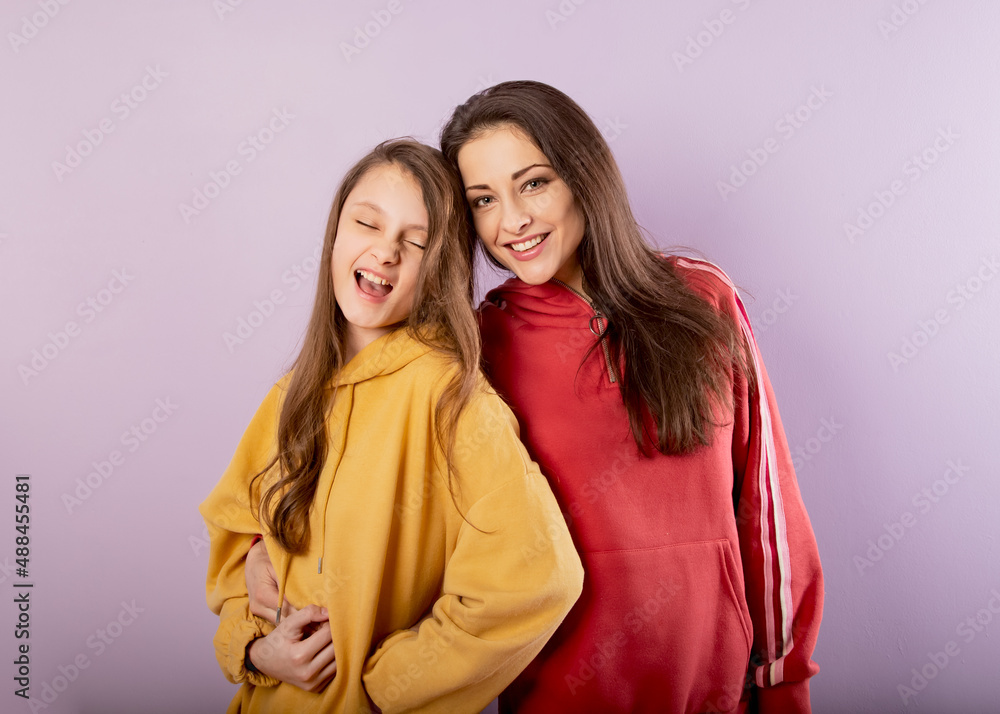 Happy smiling beautiful young mother and cute daughter posing in ...