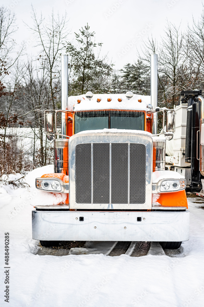 Front of big rig orange classic semi truck tractor with chrome ...