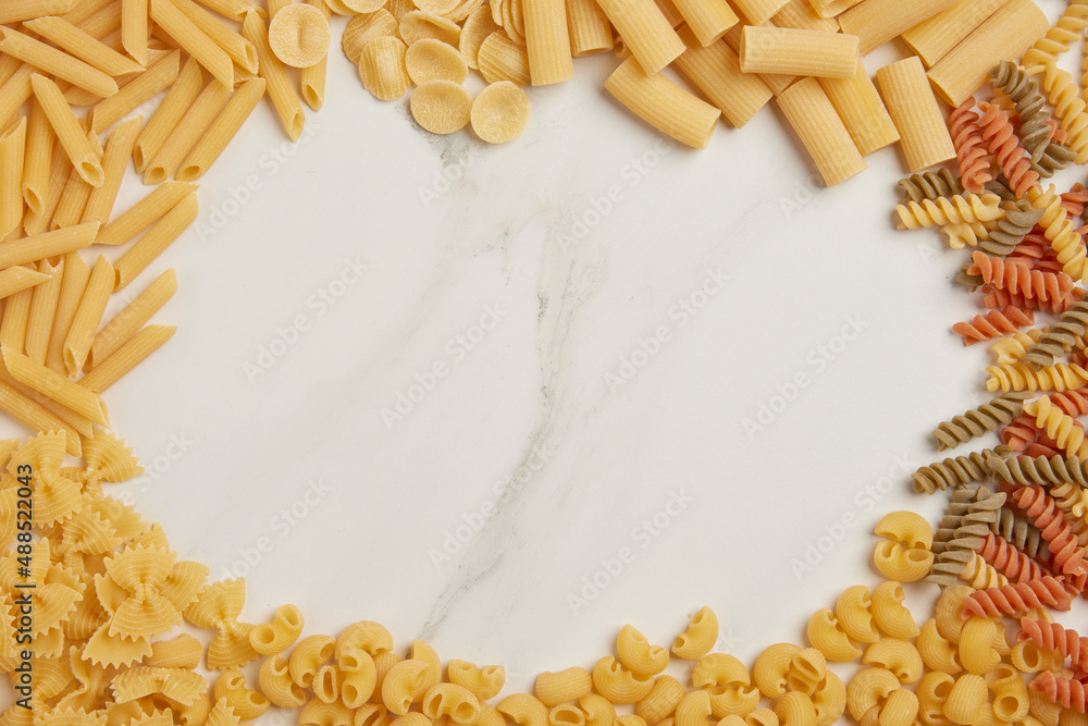 pasta concept different kinds of dry pasta being sorted into groups and ...