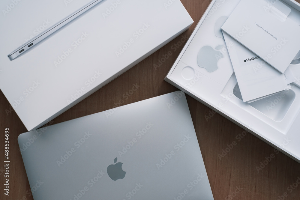Unpacking Notebook Apple Macbook Air 13 M1 silver. Top view with laptop ...