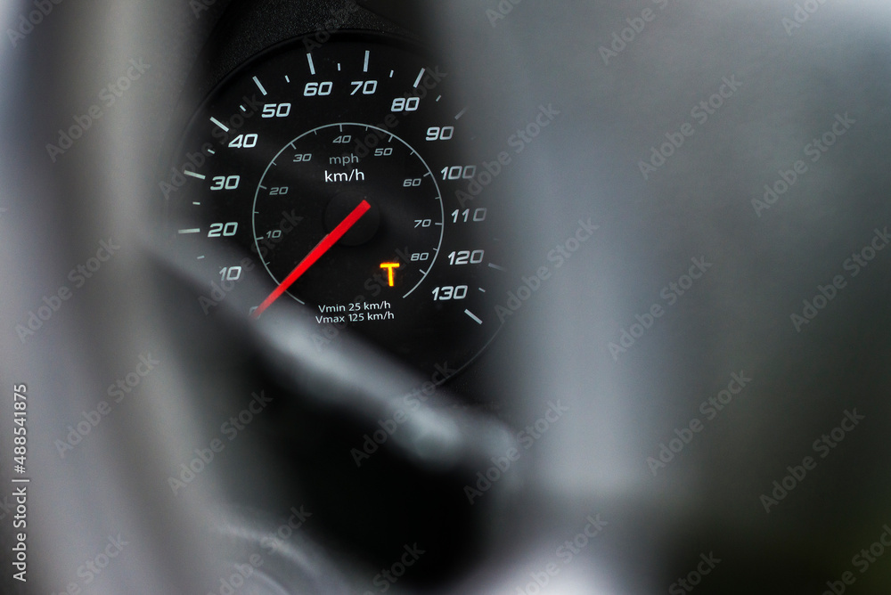 Capital T orange warning lit on speedometer of a heavy truck. Digital ...