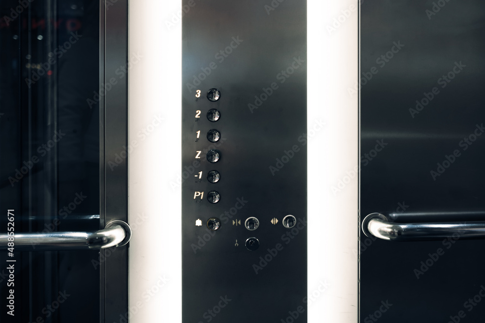 Elevator cabin, an elevator control panel with keys for floors, buttons ...