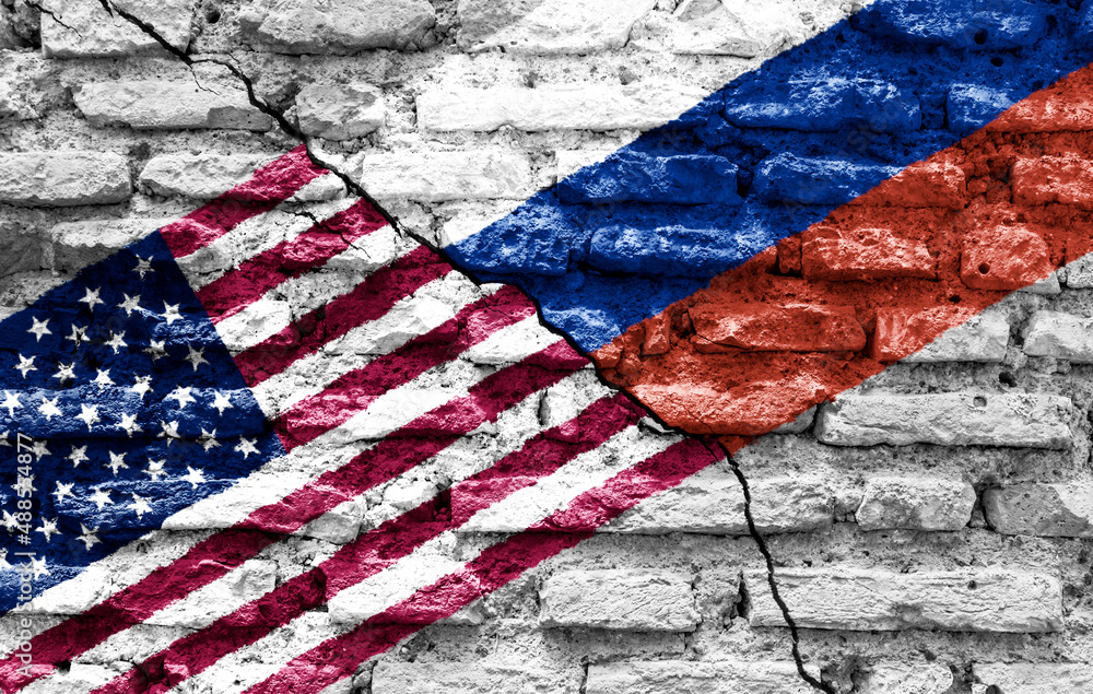 the flags of the United States and Russia painted on a ruined wall and ...