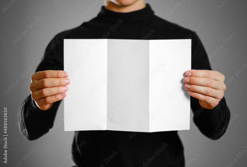 Man showing blank white flyer brochure booklet. Leaflet presentation ...