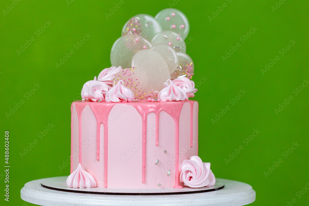 Pink cream cheese cake with chocolate chip gouges decorated with ...