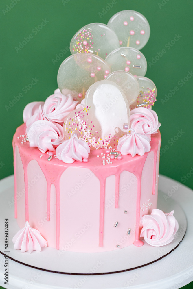 Pink cream cheese cake with chocolate chip gouges decorated with ...