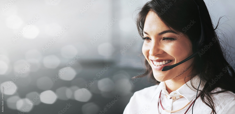Shes your direct line to business solutions. Cropped shot of a friendly ...