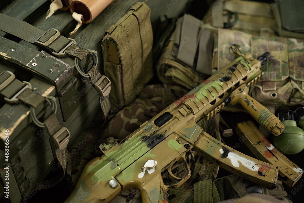 mp5 automatic rifle next to ammunition box and other military ...