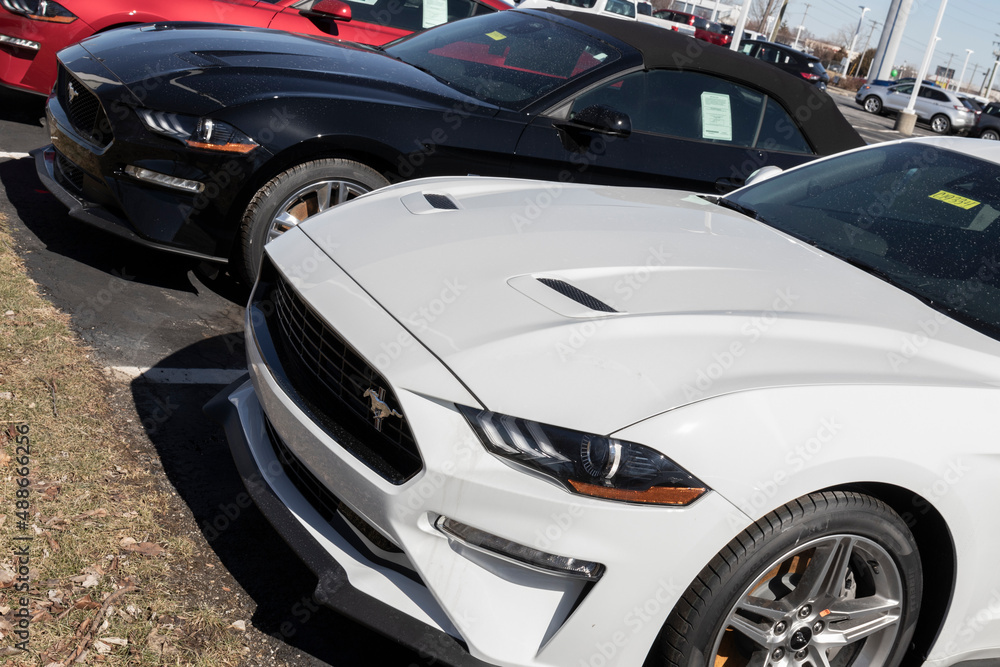Ford Mustang display at a dealership. Ford offers the Mustang in a base ...