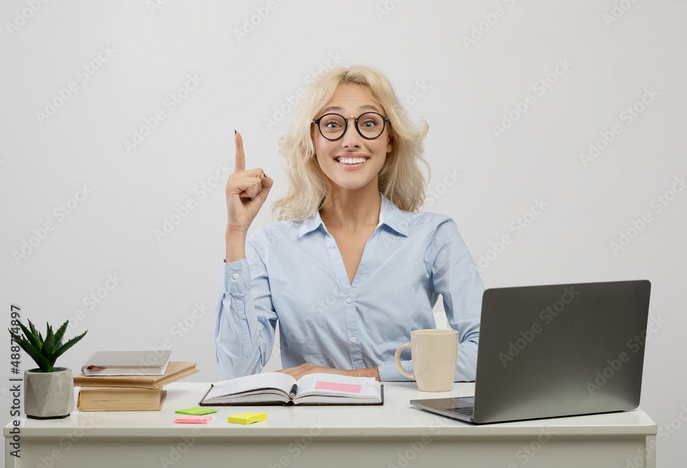 Young female office worker having creative idea, gesturing eureka at ...