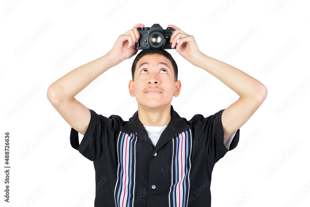 Guy holding an analog vintage camera on top of her head looking it ...