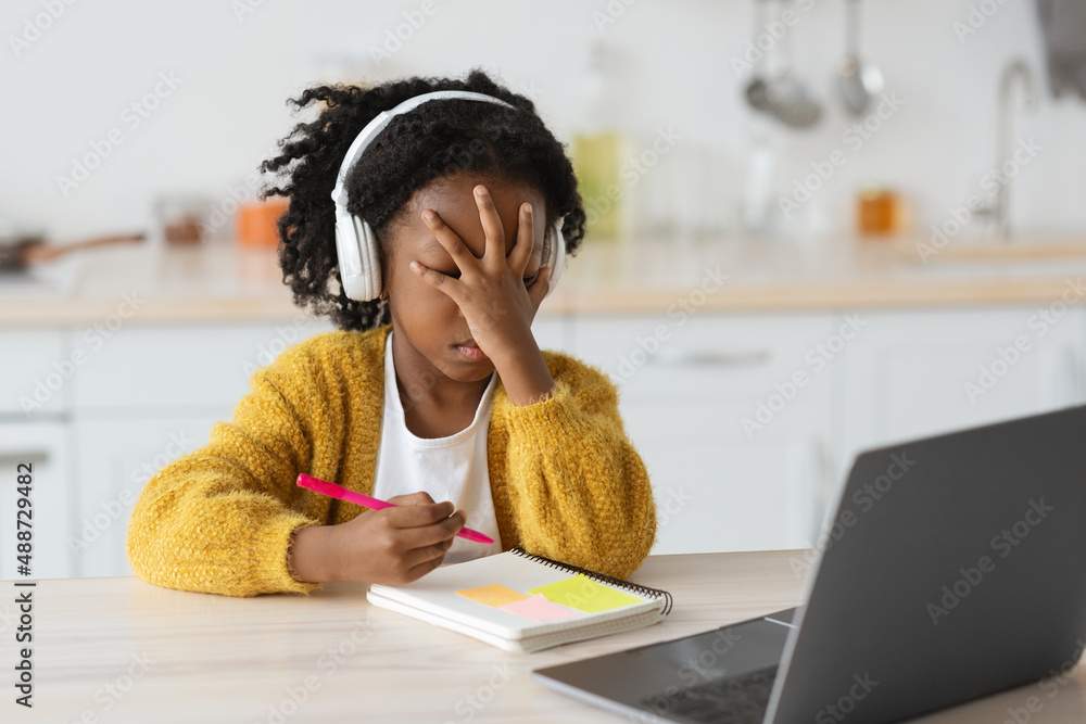 Remote Study Stress. Sad Black Little Girl Sitting At Desk With Laptop ...
