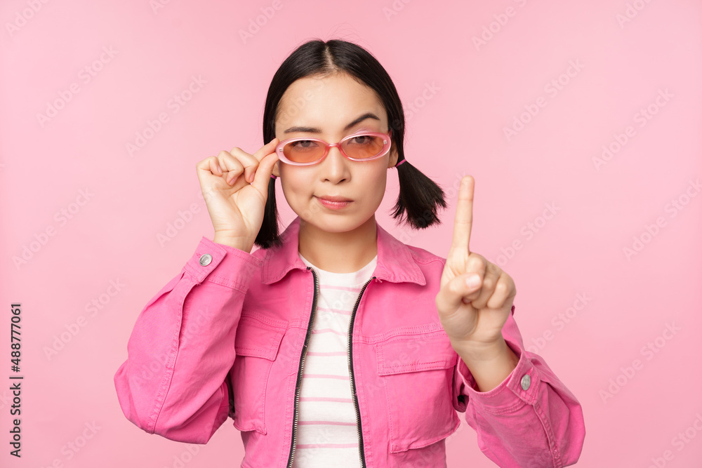 Image of asian girl with serious face, showing prohibit, scolding ...