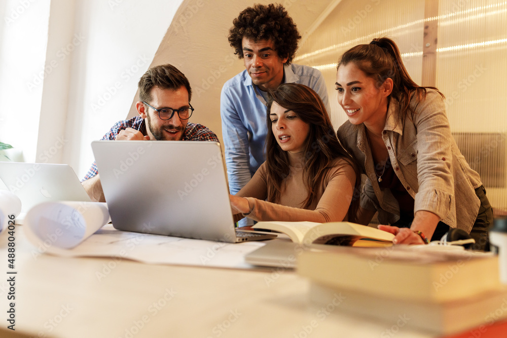 Group of casually dressed young students discussing ideas at the office ...
