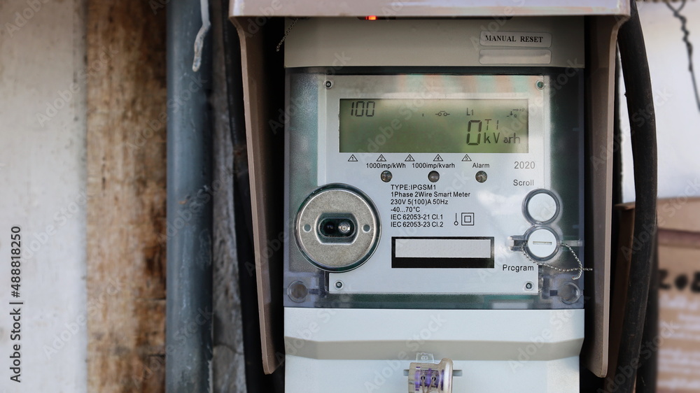 Smart meter on the wall. A close-up digital power meter or smart meter ...