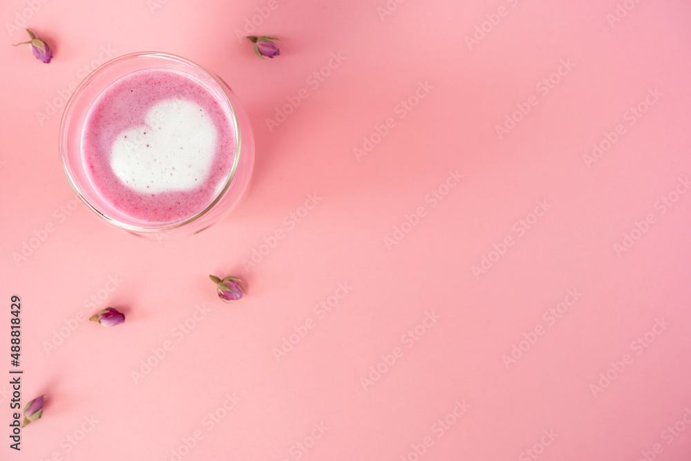 Pink rose milk with rose petals. Heart-shaped foam in a glass of moon ...