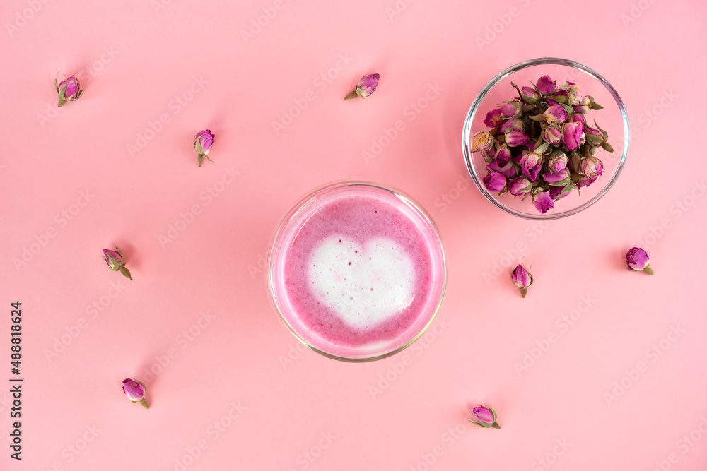 Pink rose milk with rose petals. Heart-shaped foam in a glass of moon ...