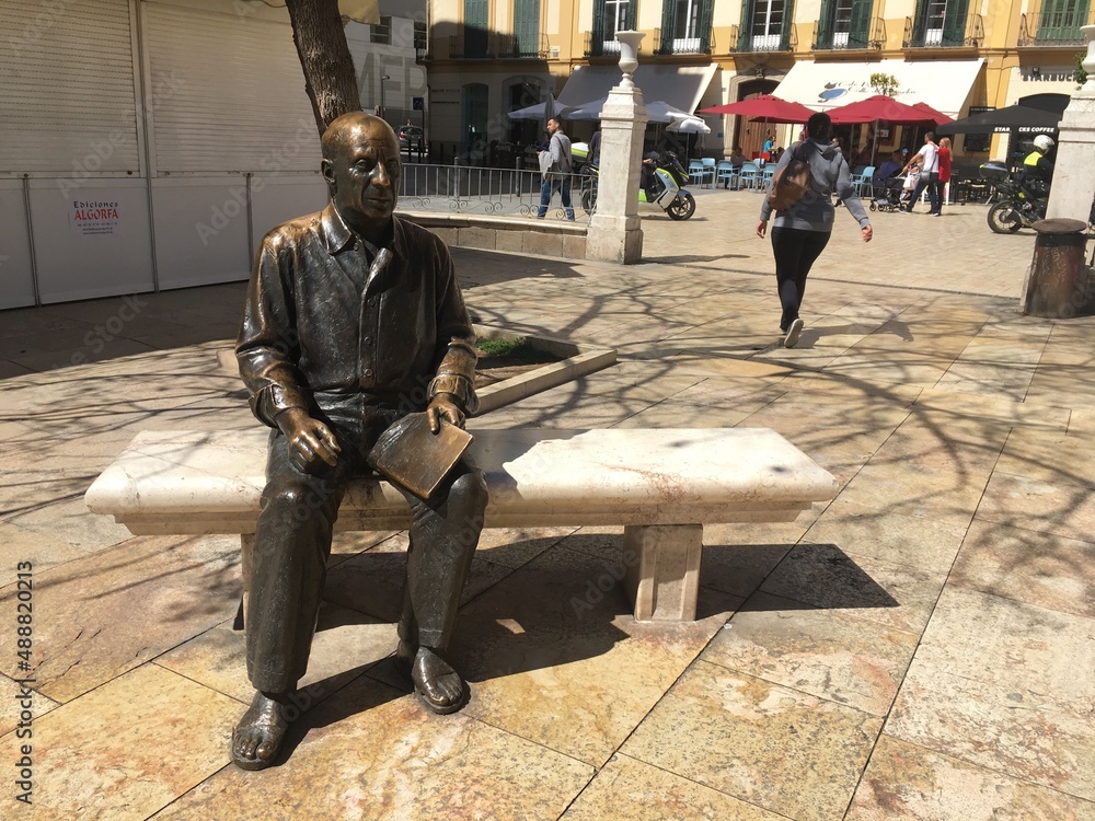 Statue sculpture of artist Pablo Picasso cast in bronze sitting on a ...