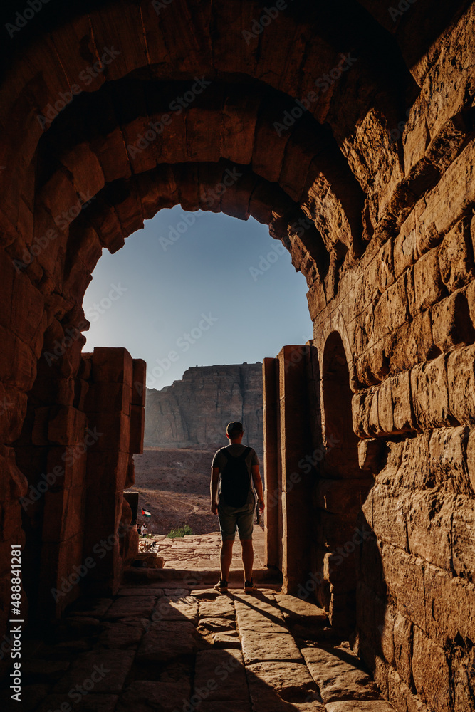 Facades in the rocks in the ancient city of Petra. Arch in ruins. Top ...