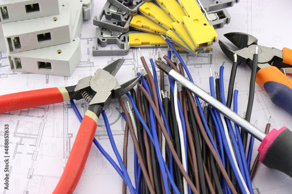 Tools for electrical installation on a close-up schematic diagram ...