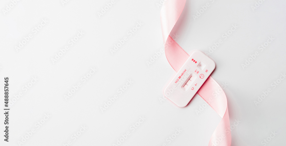 Pregnancy test kit. Positive woman pregnant test with pink silk ribbon ...