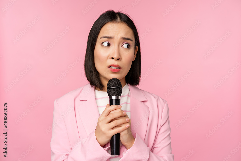 Insecure asian businesswoman giving speech, scared of talking in public ...