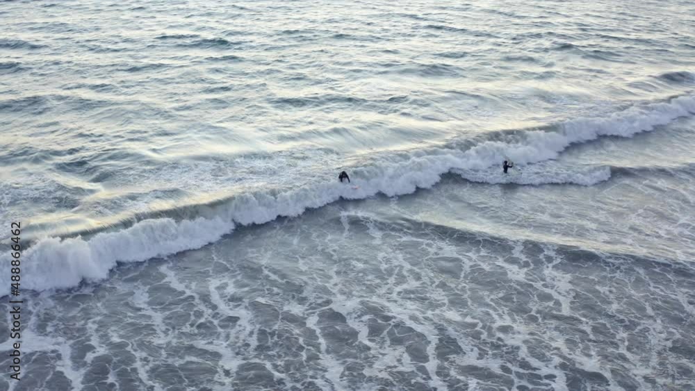 Overhead aerial, surfers in tropical water. Aerial view of surfers and ...