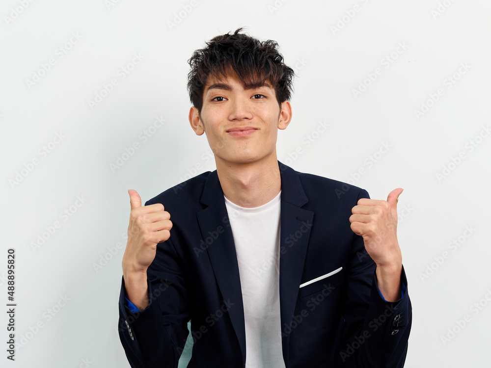 Portrait of handsome Chinese young man in dark blue leisure suit ...
