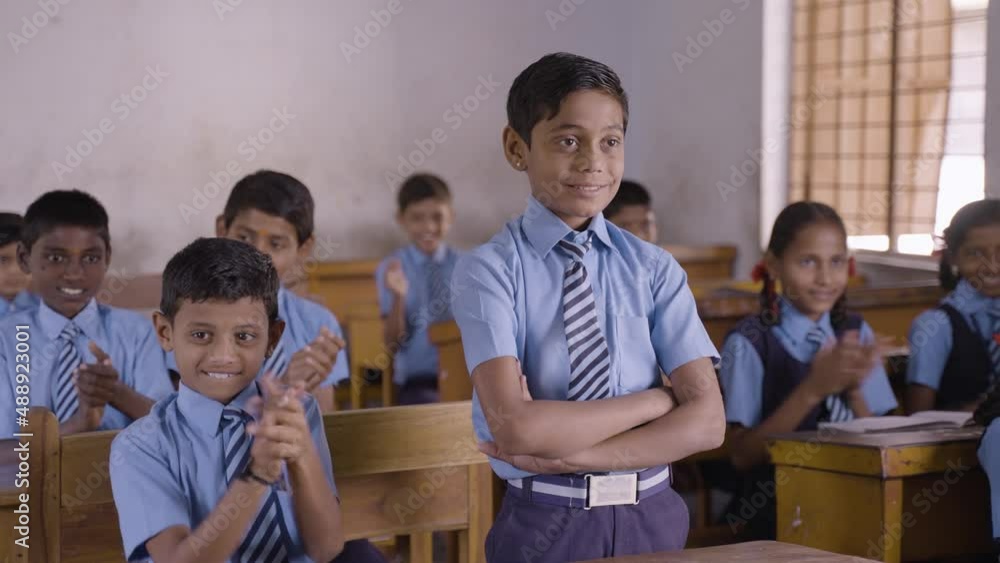 All students clapping for intelligent or brilliant kid at classroom for ...