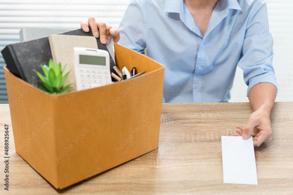 Resignation Concept The male officer sitting, putting his box of his ...