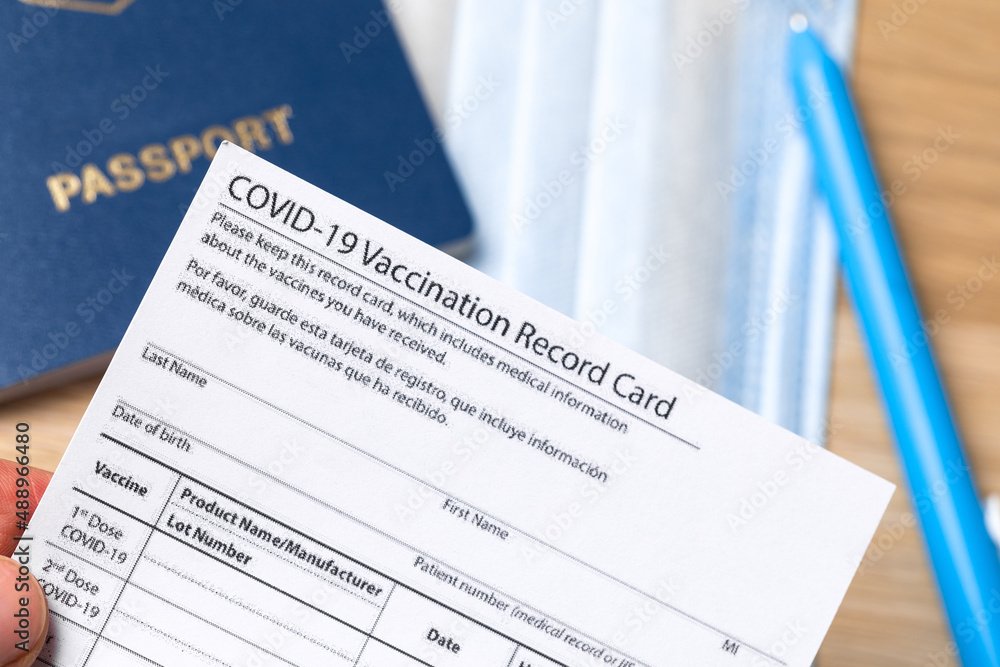 COVID-19 vaccination record card and tourist passport for worldwide ...