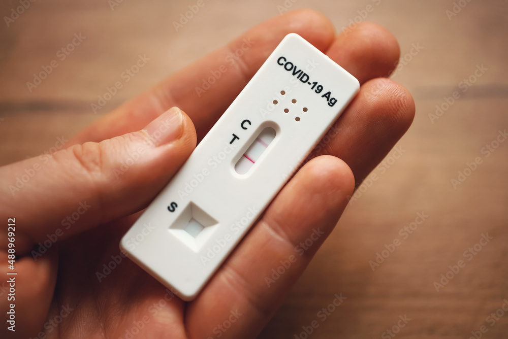 Man holding Positive Antigen Rapid Test for Coronavirus. Stock Photo ...
