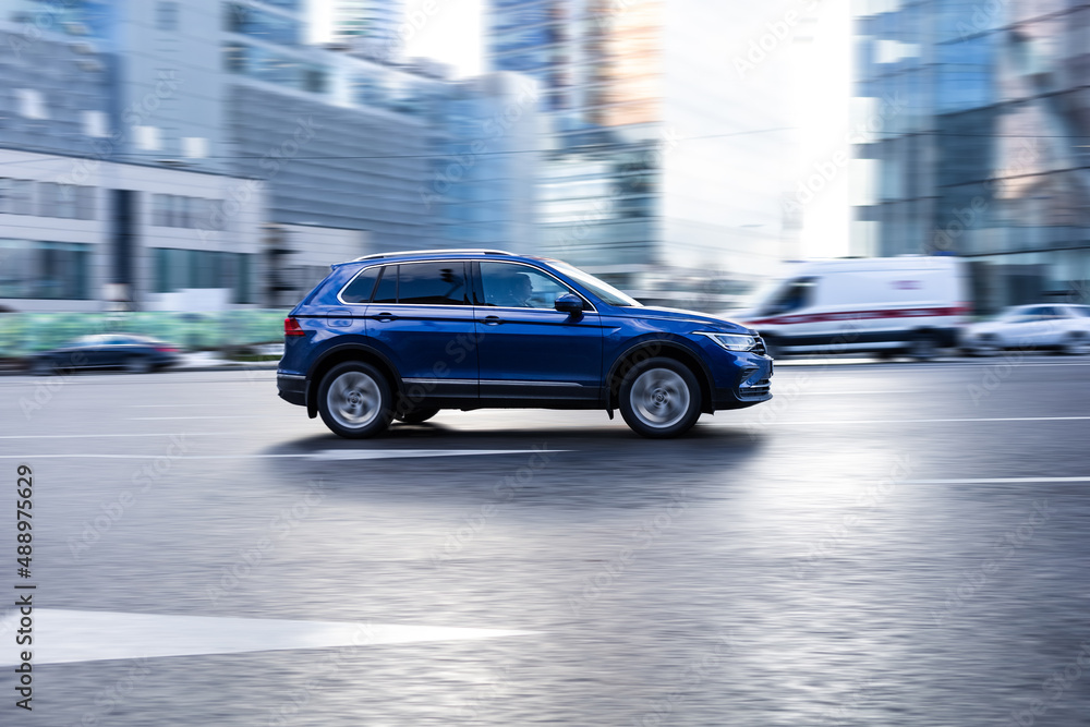 fast moving SUV rides on a highway road. Car on asphalt road in motion ...