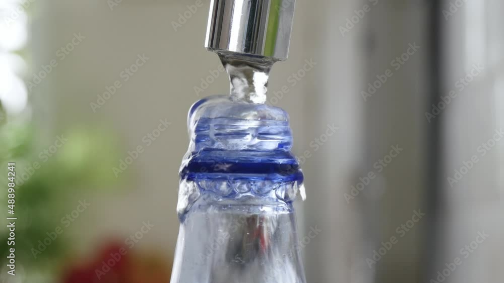 Filling a Plastic Bottle with Fresh Water. Making Water Reserve in a ...