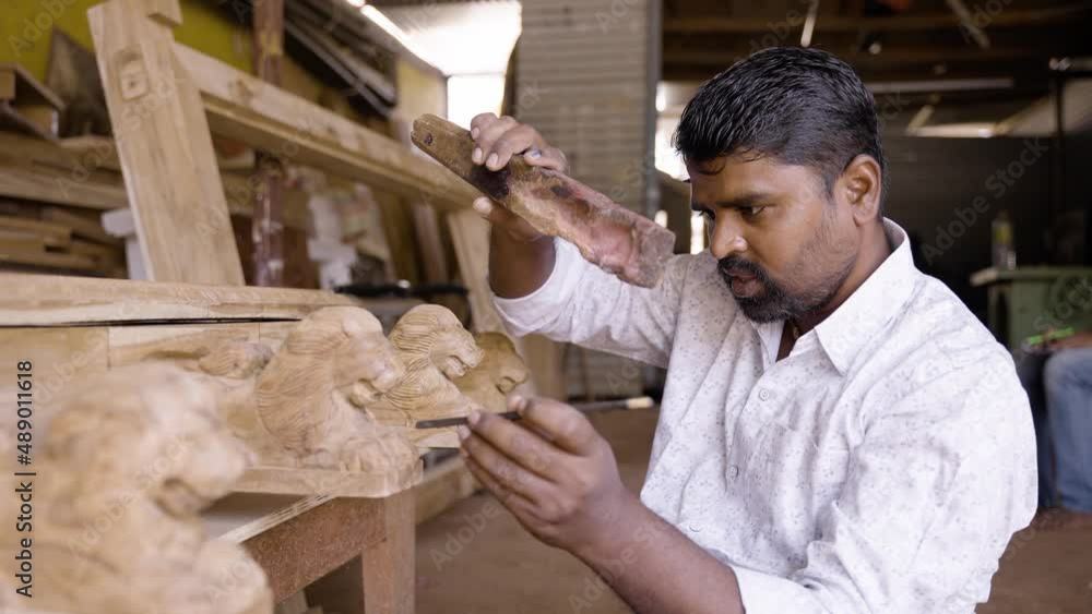 carpenter busy making wood design by shaping using carpentry tools at ...