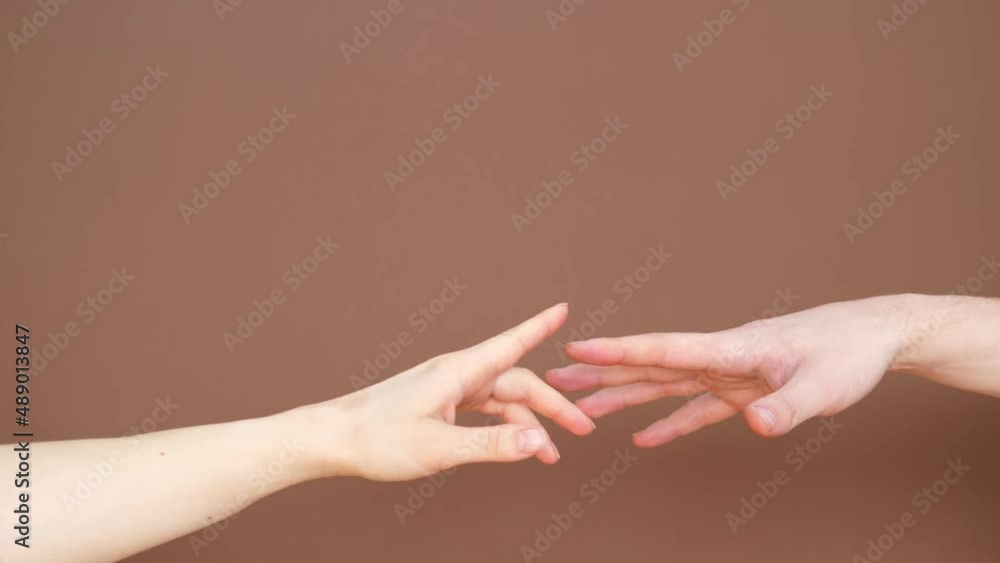 Hands of a man and a woman reach out to each other, a symbol of care ...