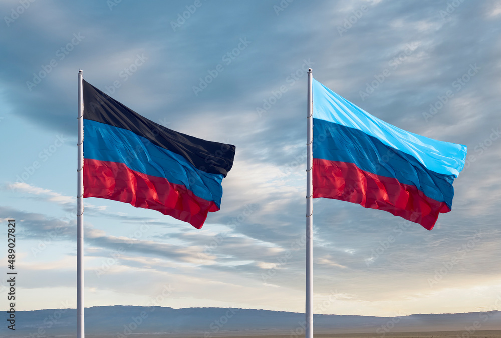 Flags of the Donetsk and Lugansk People's Republics against a cloudy ...