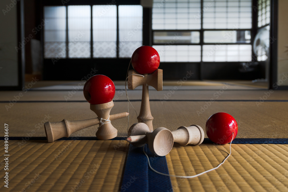 Kendama, a traditional Japanese game, displayed on a tatami floor in a ...