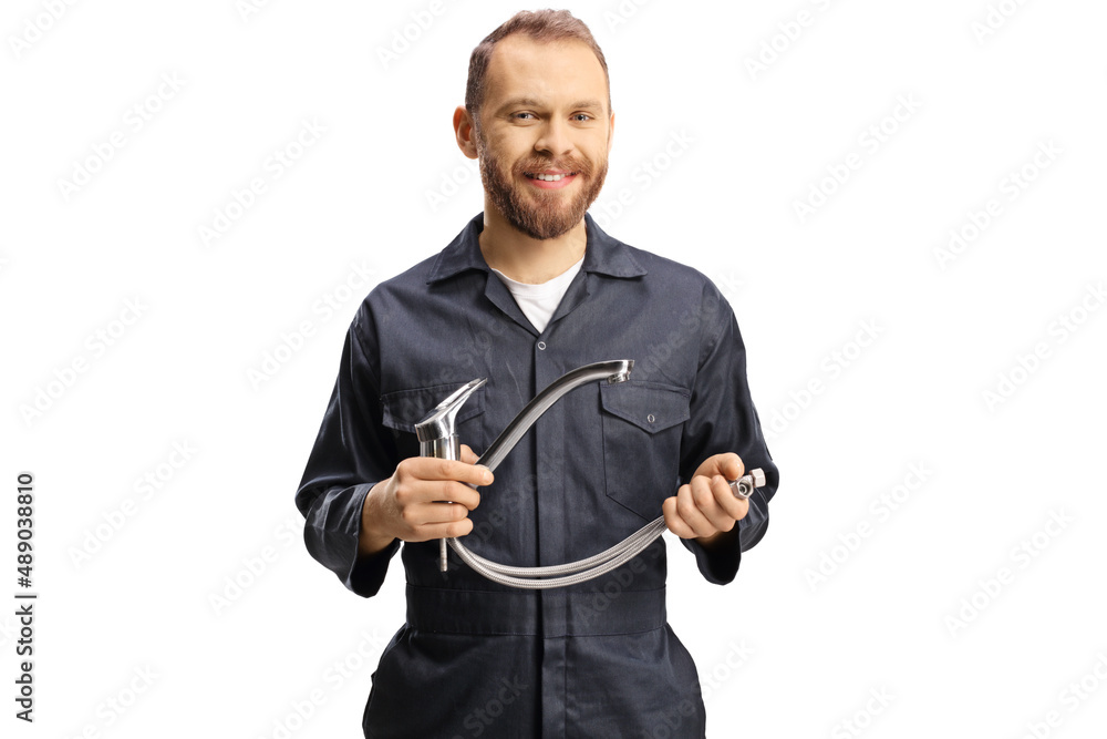 Plumber in a uniform holding a steel hose and a tap Stock Photo | Adobe ...