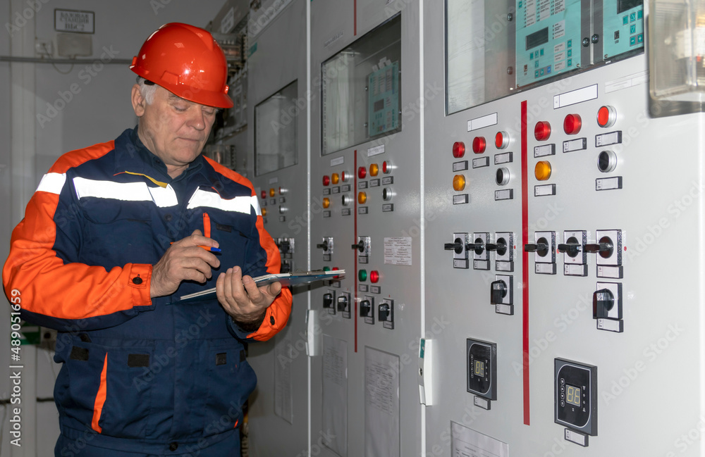 A worker at a power plant. An electrician works at a power plant. A man ...