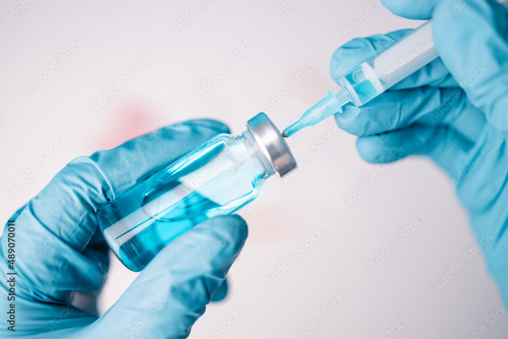 Doctor or scientist holding syringe with syringe with booster dose ...