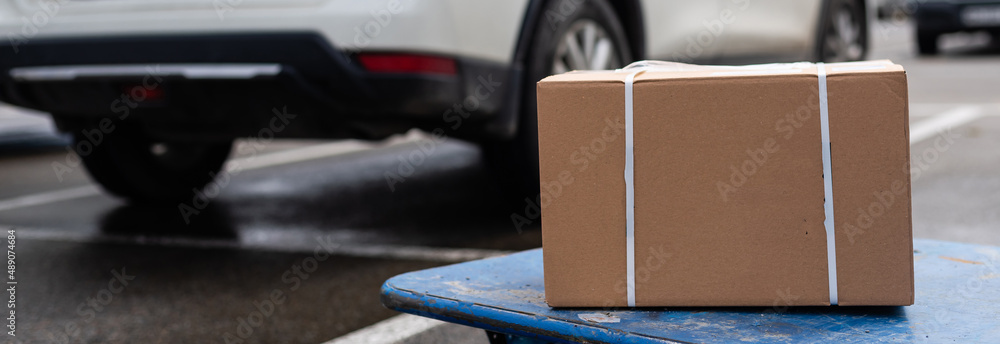 Brown cardboard moving box in the cart Stock Photo | Adobe Stock