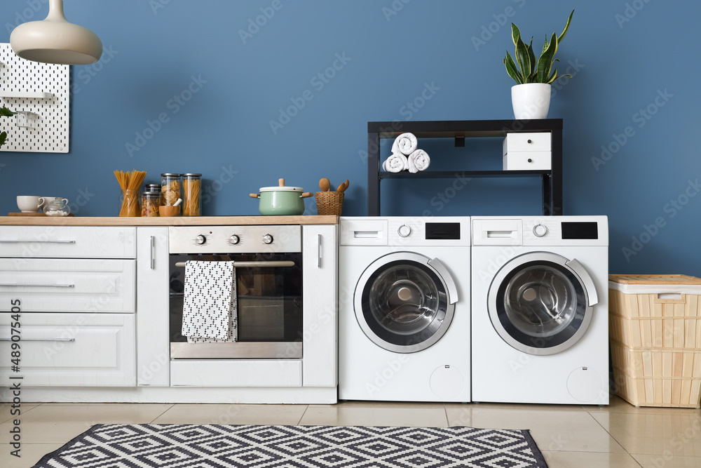 Interior of stylish kitchen with modern washing machines and oven Stock ...