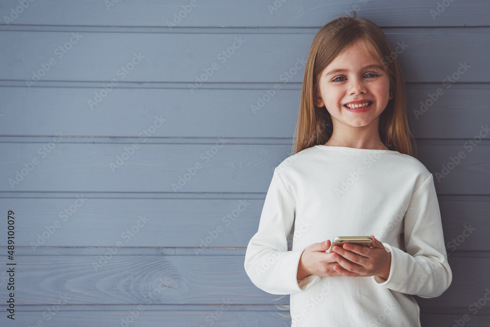 Little girl with gadget Stock Photo | Adobe Stock