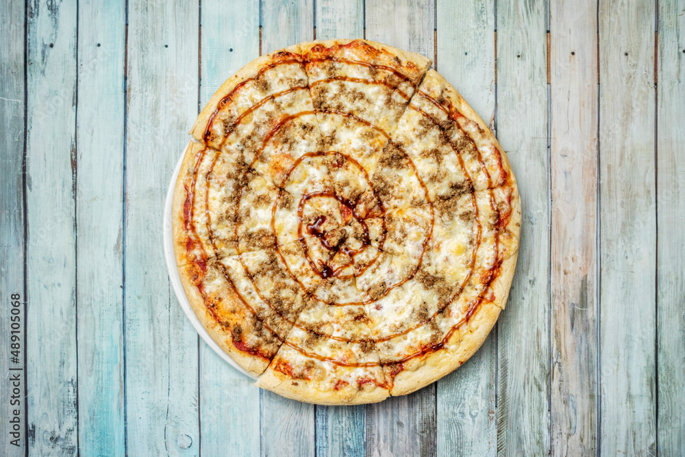 Portioned pizza with minced meat, lots of mozzarella cheese and a ...