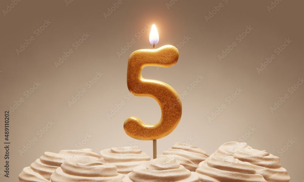 5th birthday or anniversary celebration. Lit golden number candle on ...