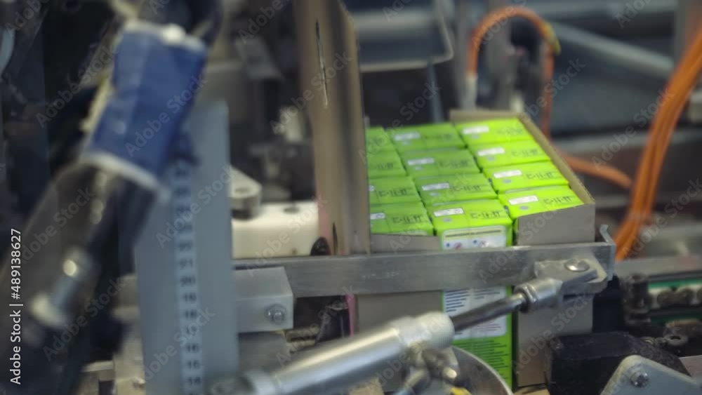 Dairy Product are moving on an automated production line. Small Boxes ...