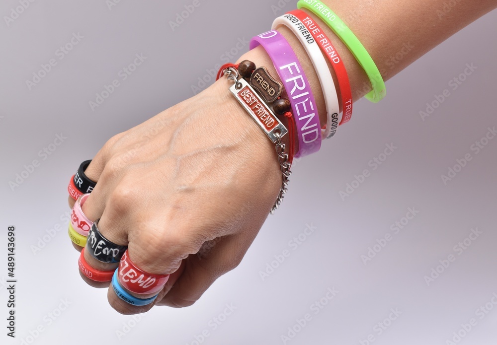 Hand full of friendship bands and ring on the occasion of friendship ...