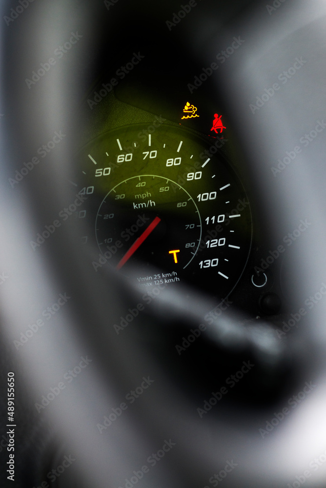 Capital T orange warning lit on speedometer of a heavy truck. Digital ...